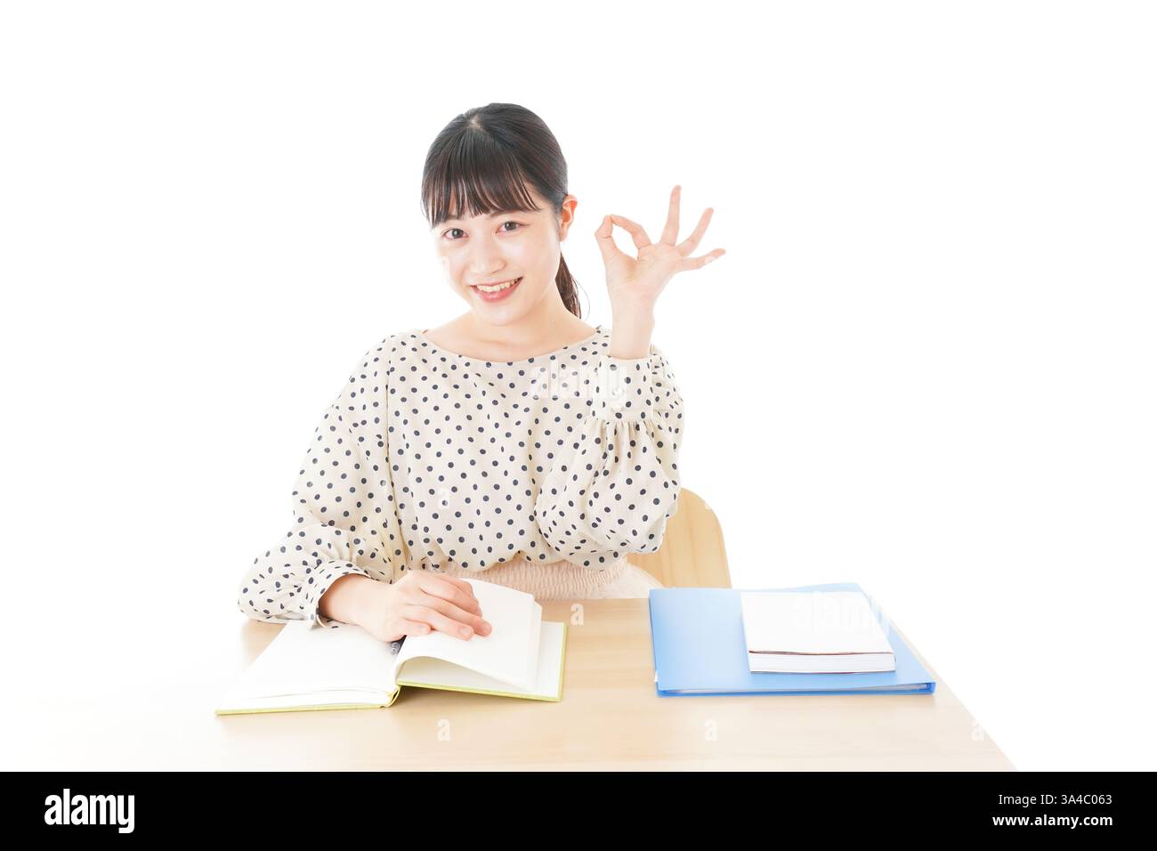 Young woman studying at desk Stock Photo - Alamy