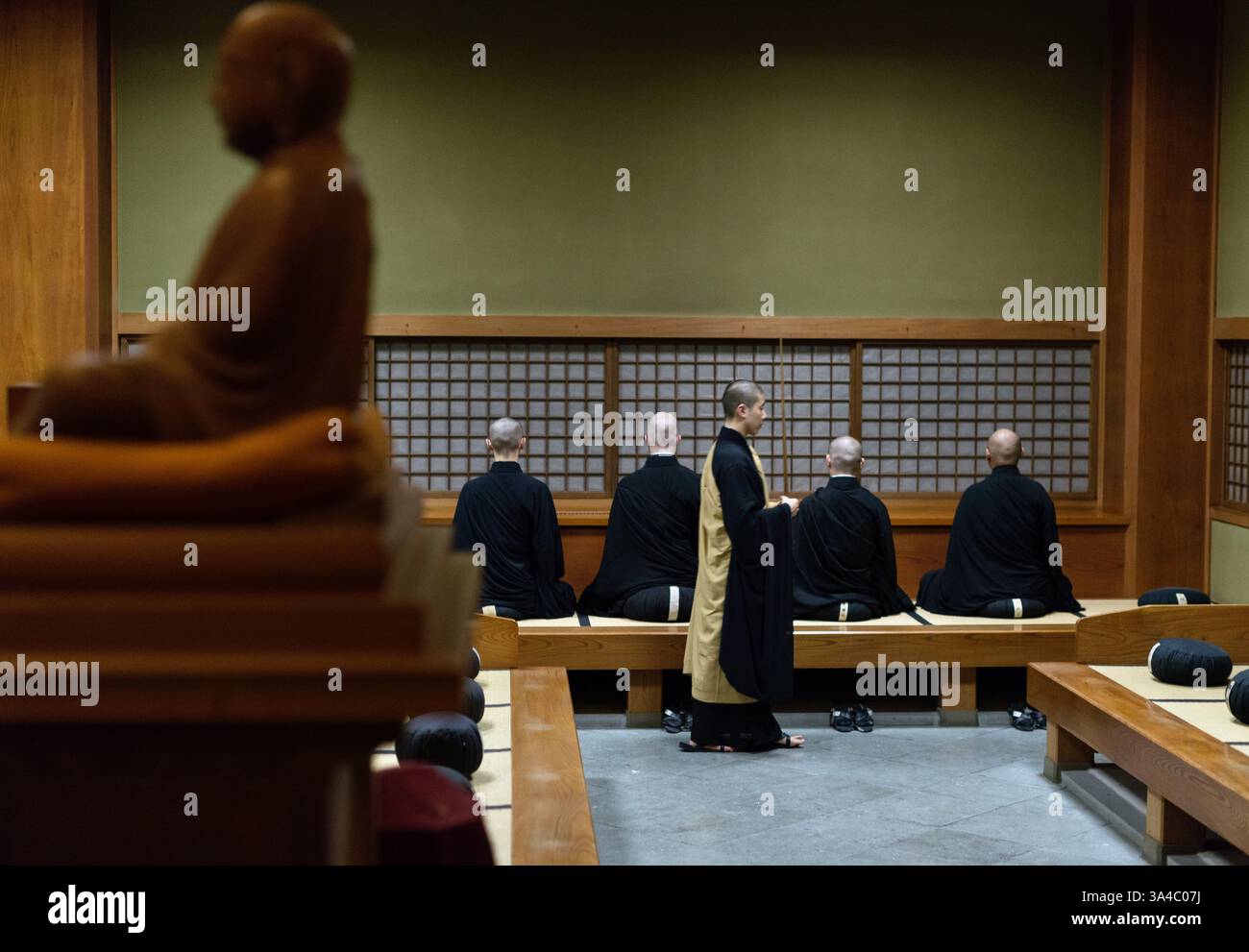 Photo shows priests training in zazen meditation inside the Sodo, or ...