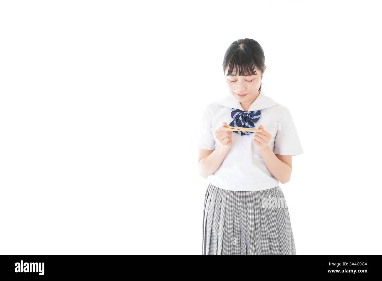 Schoolgirl in school uniform handing out letter Stock Photo - Alamy