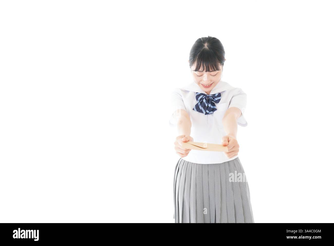 Schoolgirl in school uniform handing out letter Stock Photo - Alamy