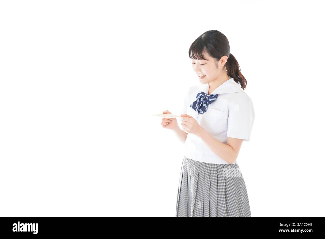 Schoolgirl in school uniform handing out letter Stock Photo - Alamy