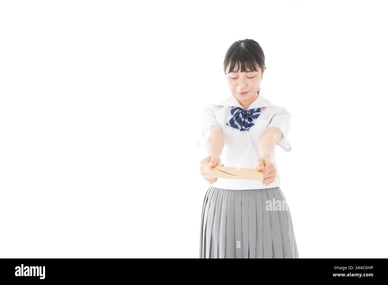Schoolgirl in school uniform handing out letter Stock Photo - Alamy