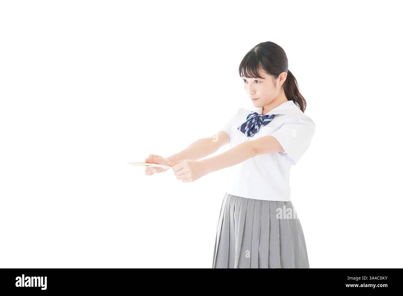 Schoolgirl in school uniform handing out letter Stock Photo - Alamy