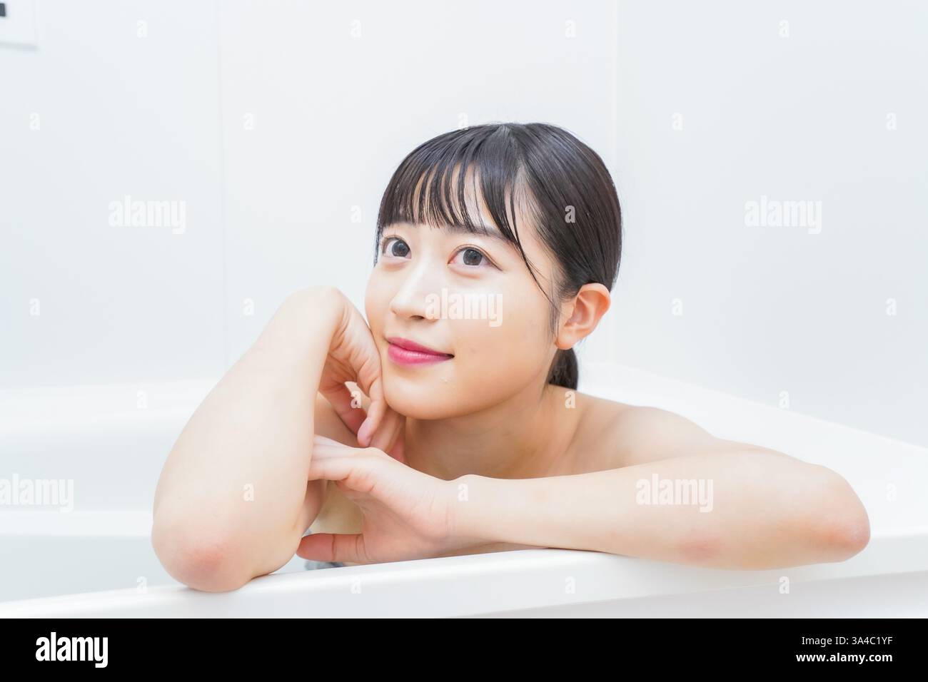 Young woman soaking in hot water in the bath Stock Photo - Alamy