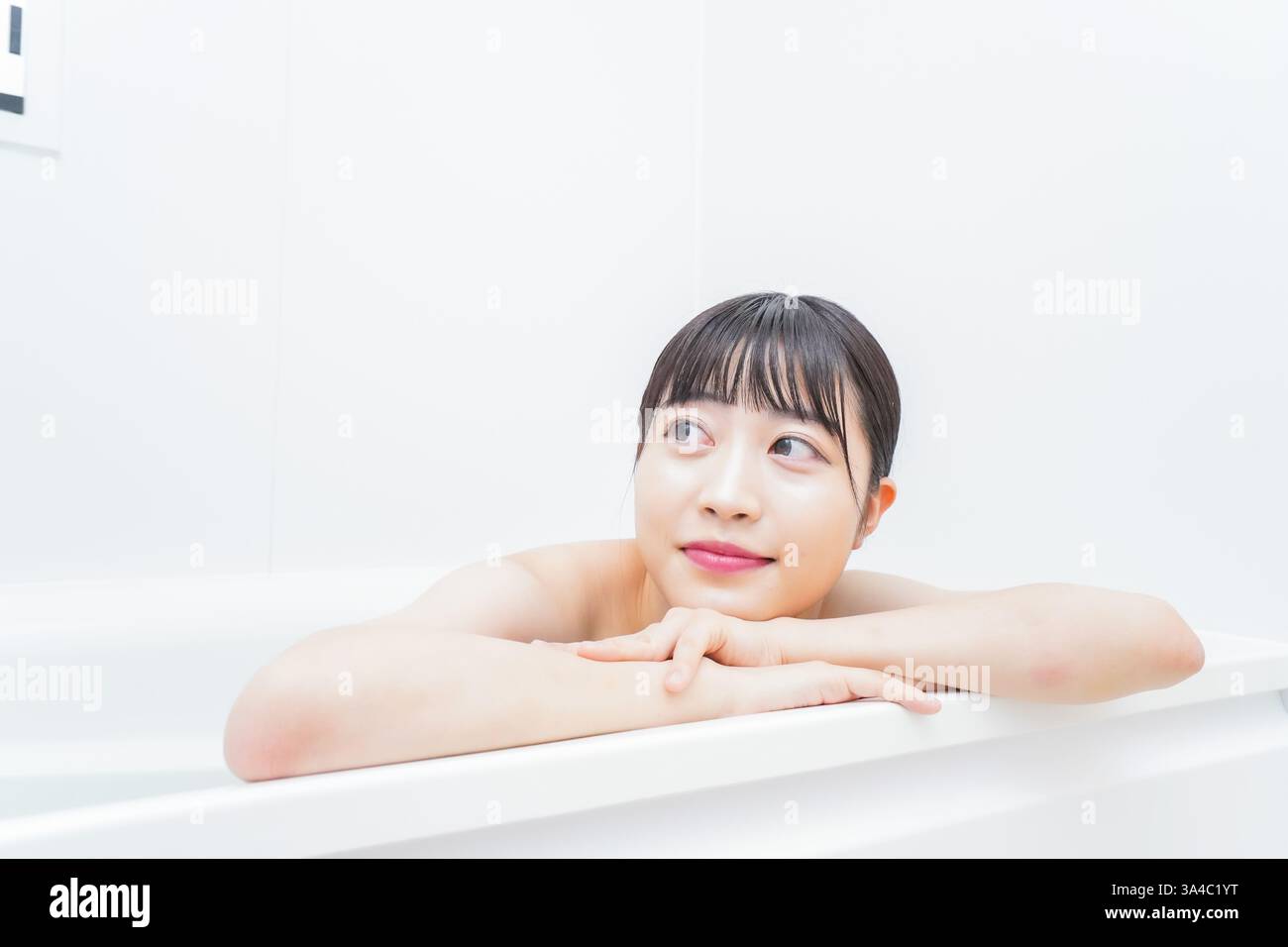 Young woman soaking in hot water in the bath Stock Photo - Alamy