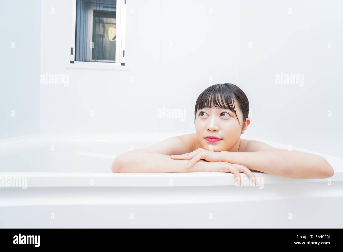 Young woman soaking in hot water in the bath Stock Photo - Alamy