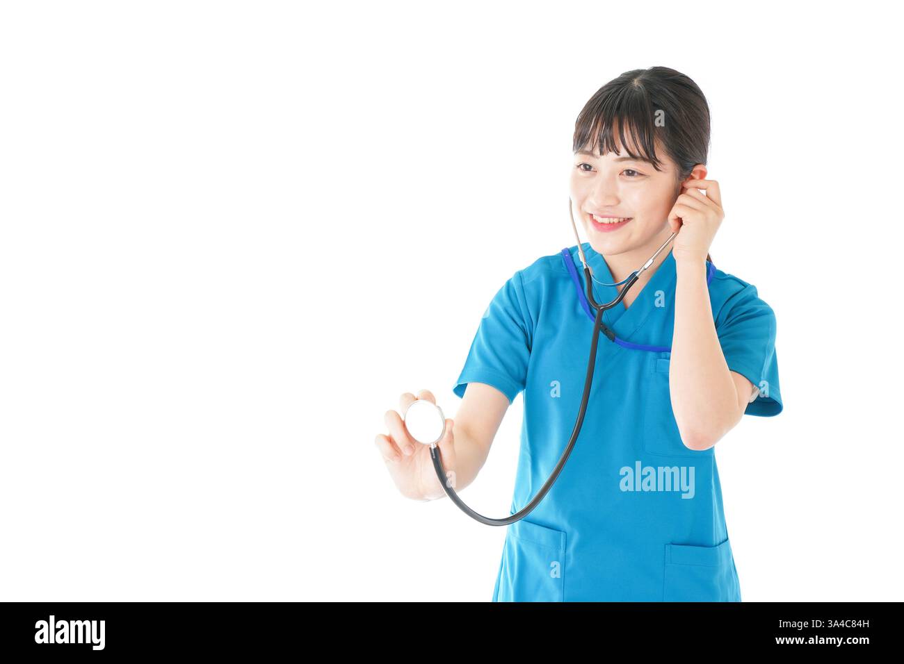 Smiling young nurse using stethoscope Stock Photo - Alamy
