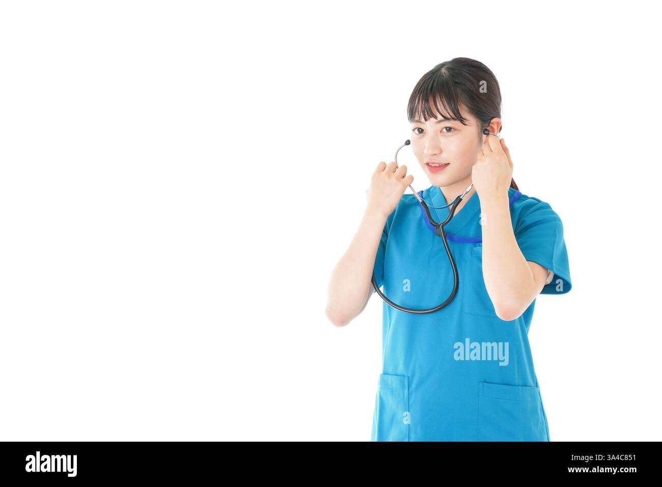 Smiling young nurse using stethoscope Stock Photo - Alamy