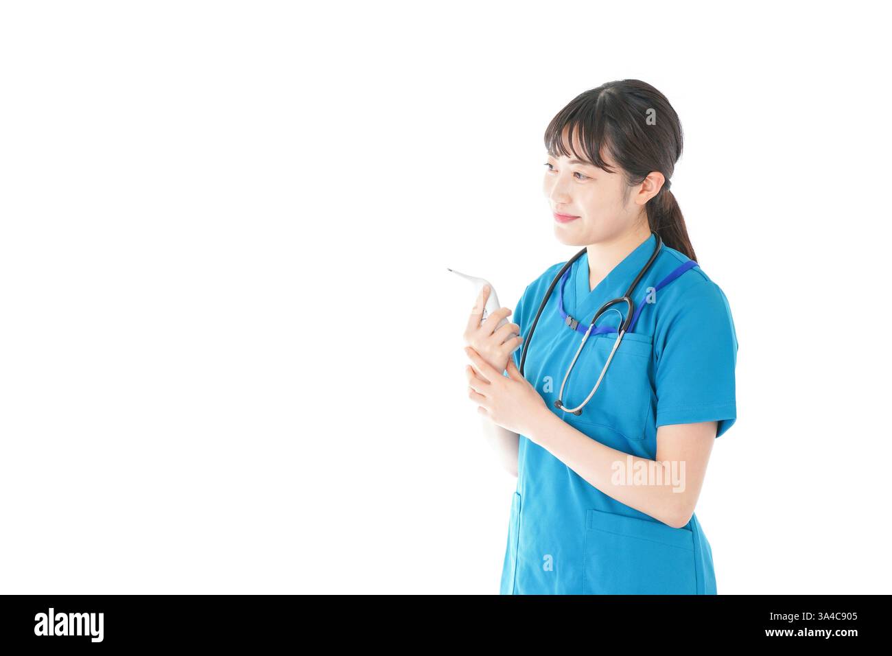 Smiling young nurse taking body temperature Stock Photo - Alamy