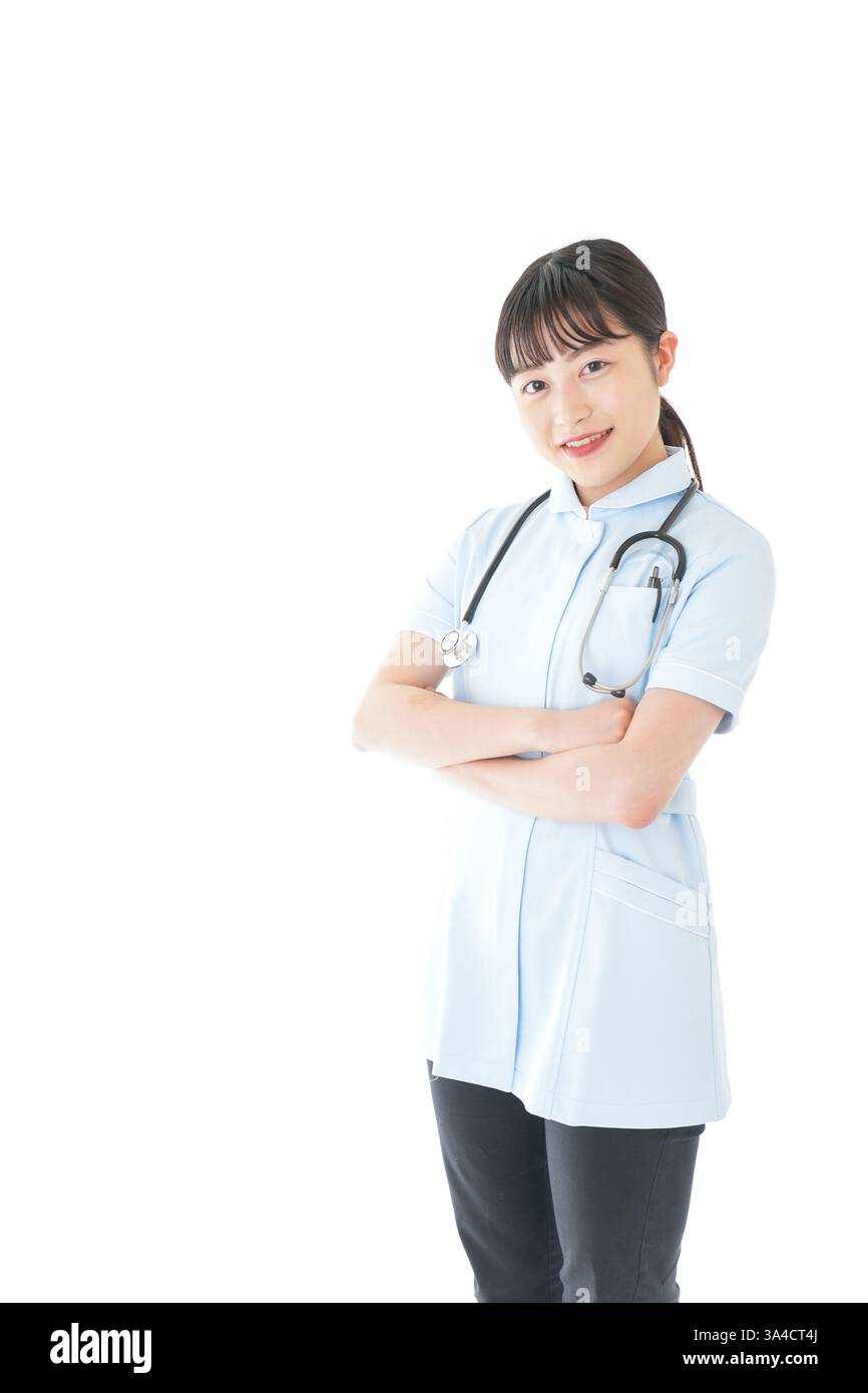 Young nurse with arms folded Stock Photo - Alamy