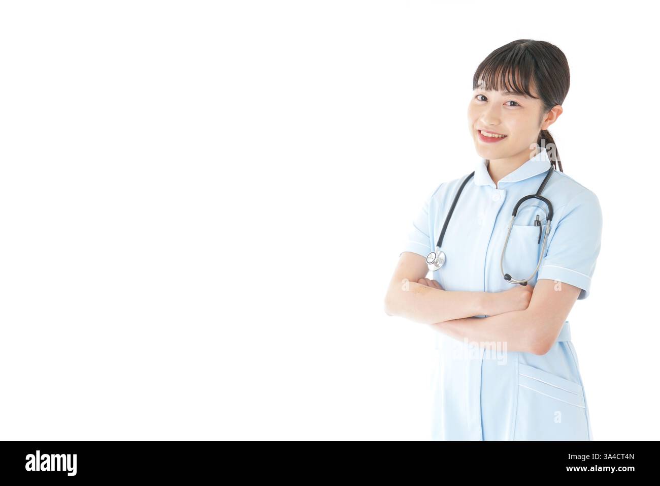 Young nurse with arms folded Stock Photo - Alamy