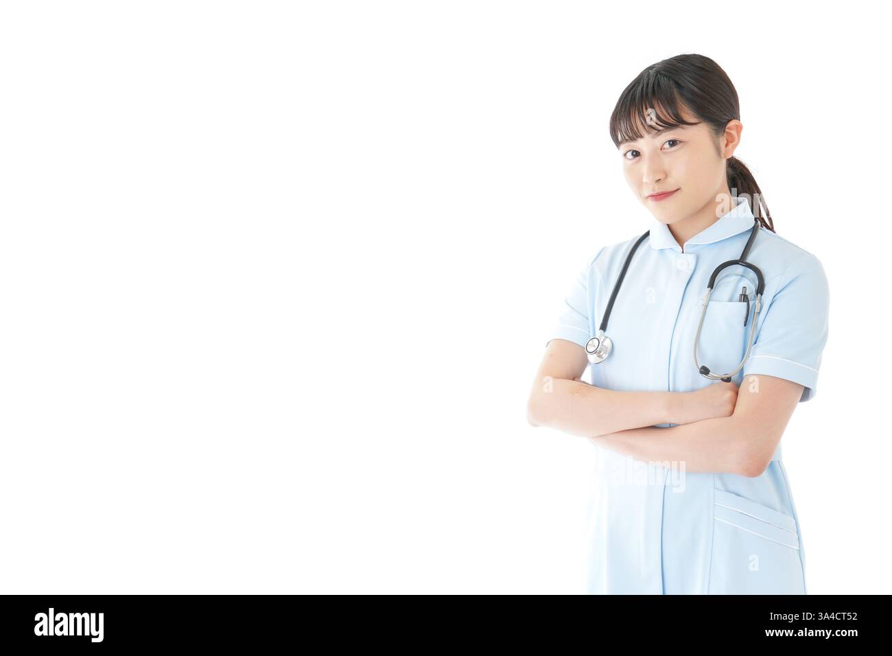 Young nurse with arms folded Stock Photo - Alamy