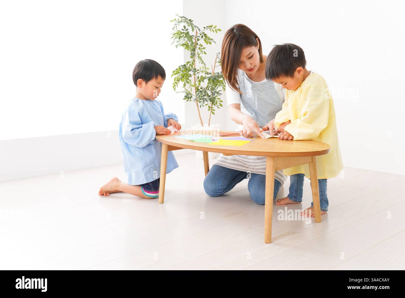 Children and teacher doing origami at the kindergarten Stock Photo - Alamy