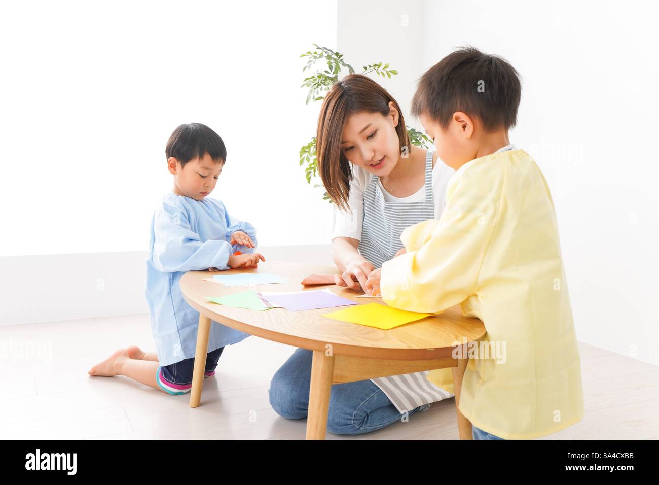 Children and teacher doing origami at the kindergarten Stock Photo - Alamy