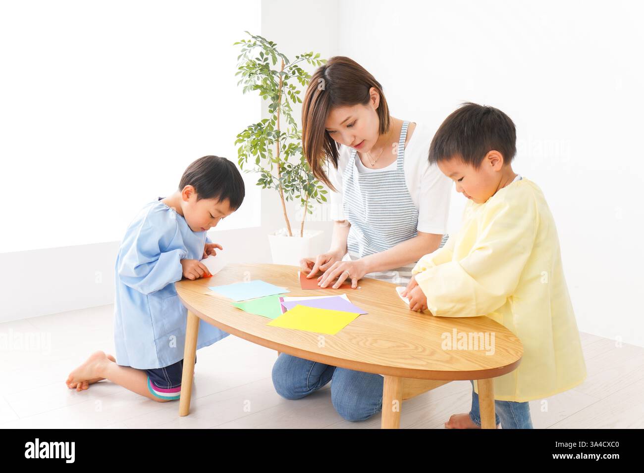 Children and teacher doing origami at the kindergarten Stock Photo - Alamy