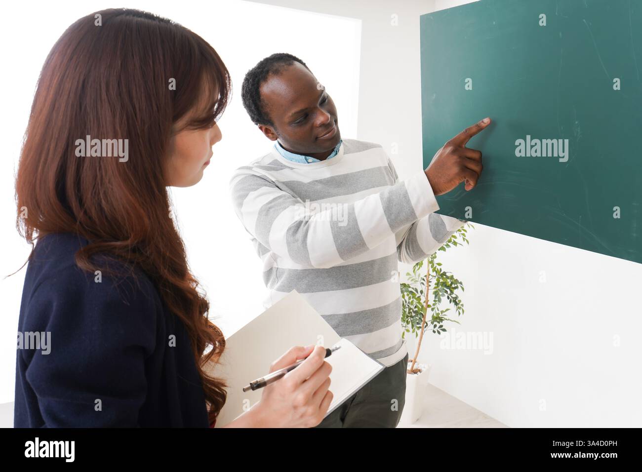 Woman taking a class from a native teacher Stock Photo - Alamy