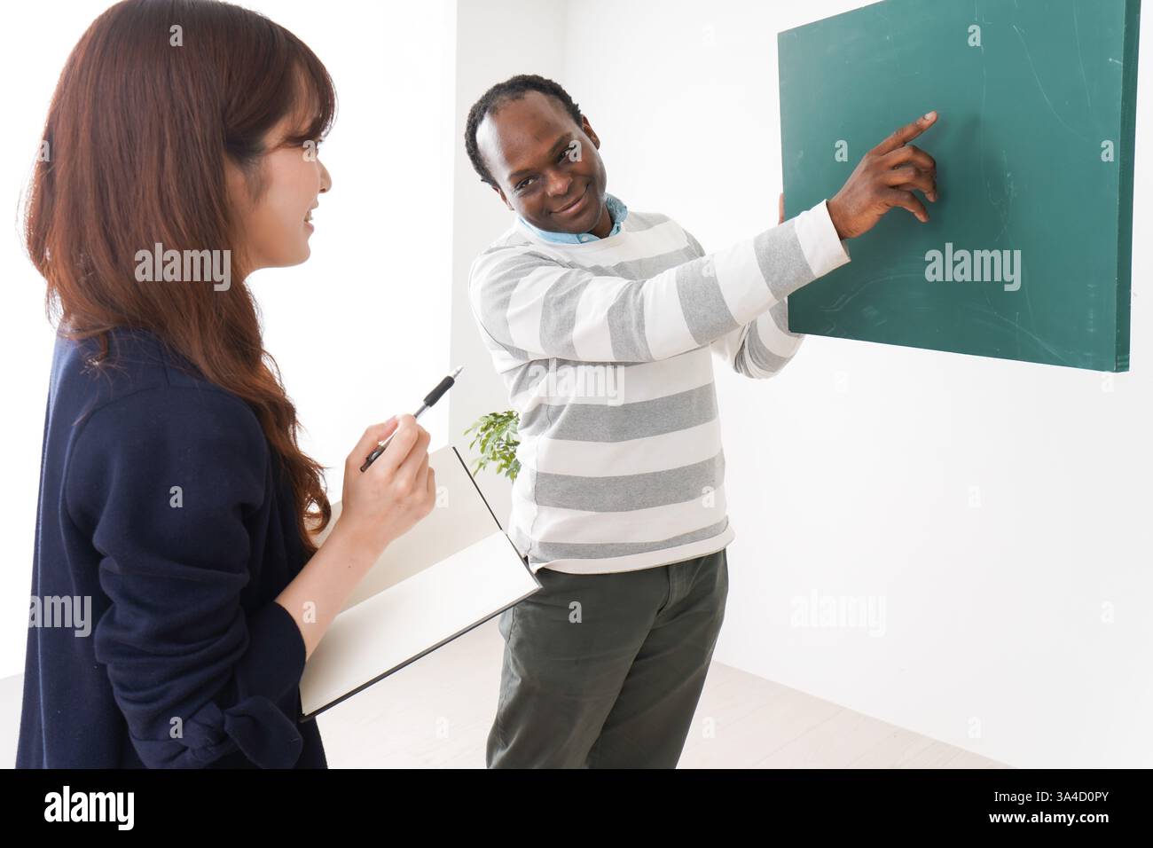 Woman taking a class from a native teacher Stock Photo - Alamy