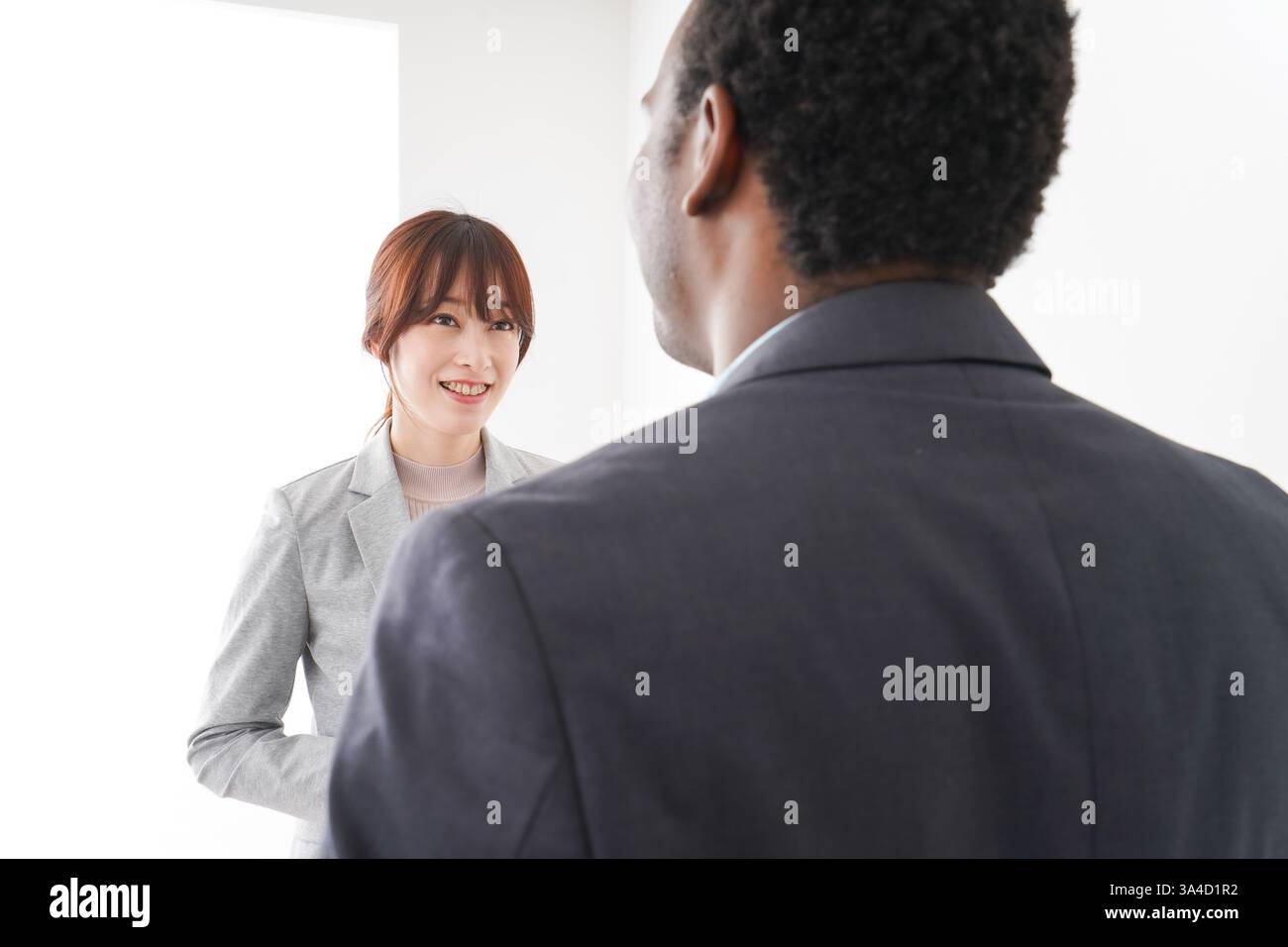 Two business people exchanging views in an office Stock Photo - Alamy