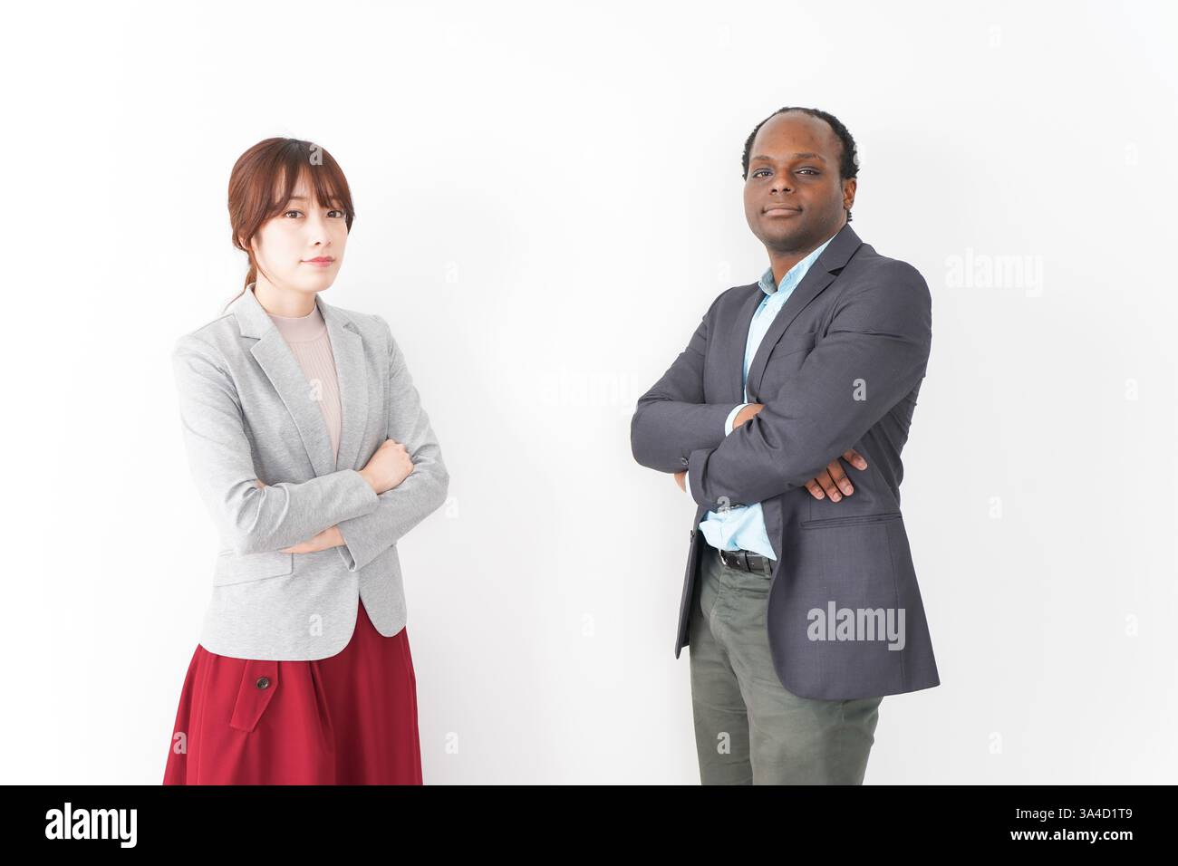 Two business people with their arms crossed Stock Photo - Alamy
