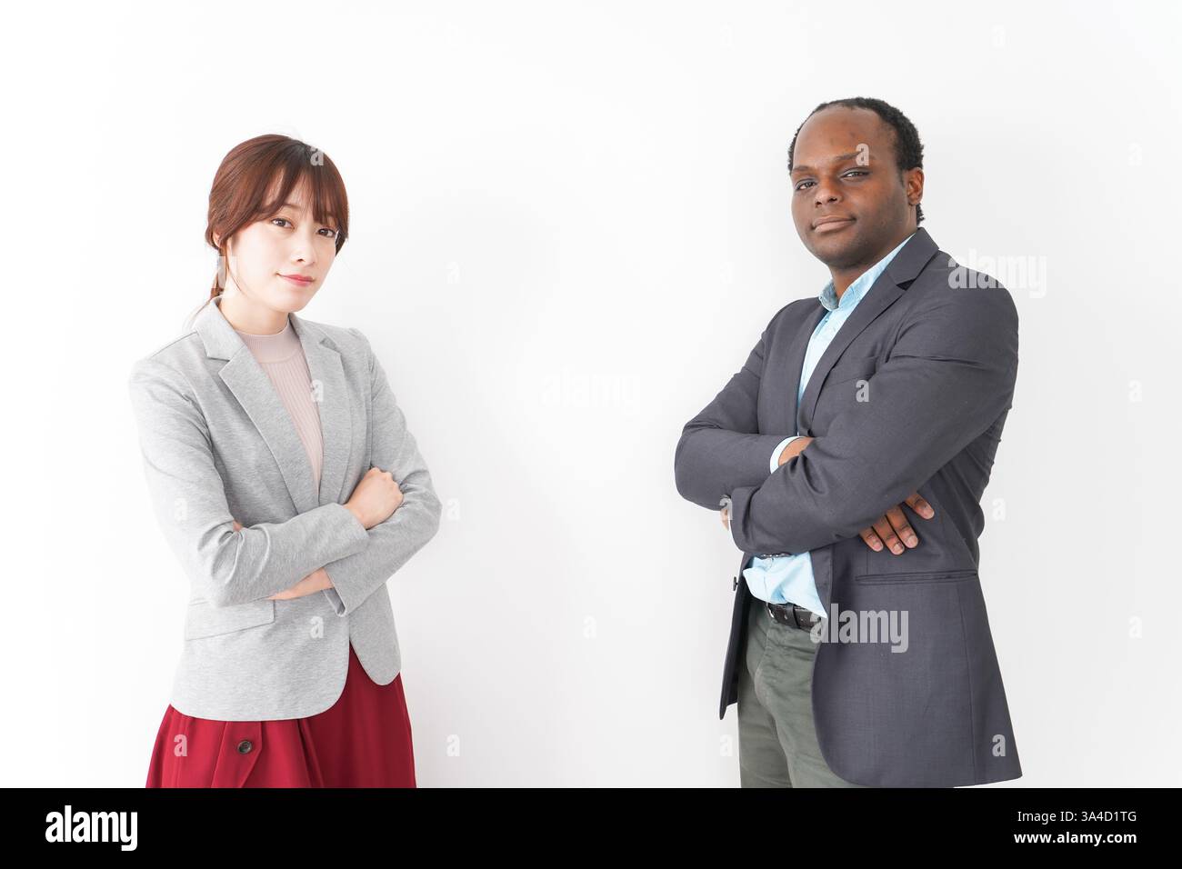 Two business people with their arms crossed Stock Photo - Alamy