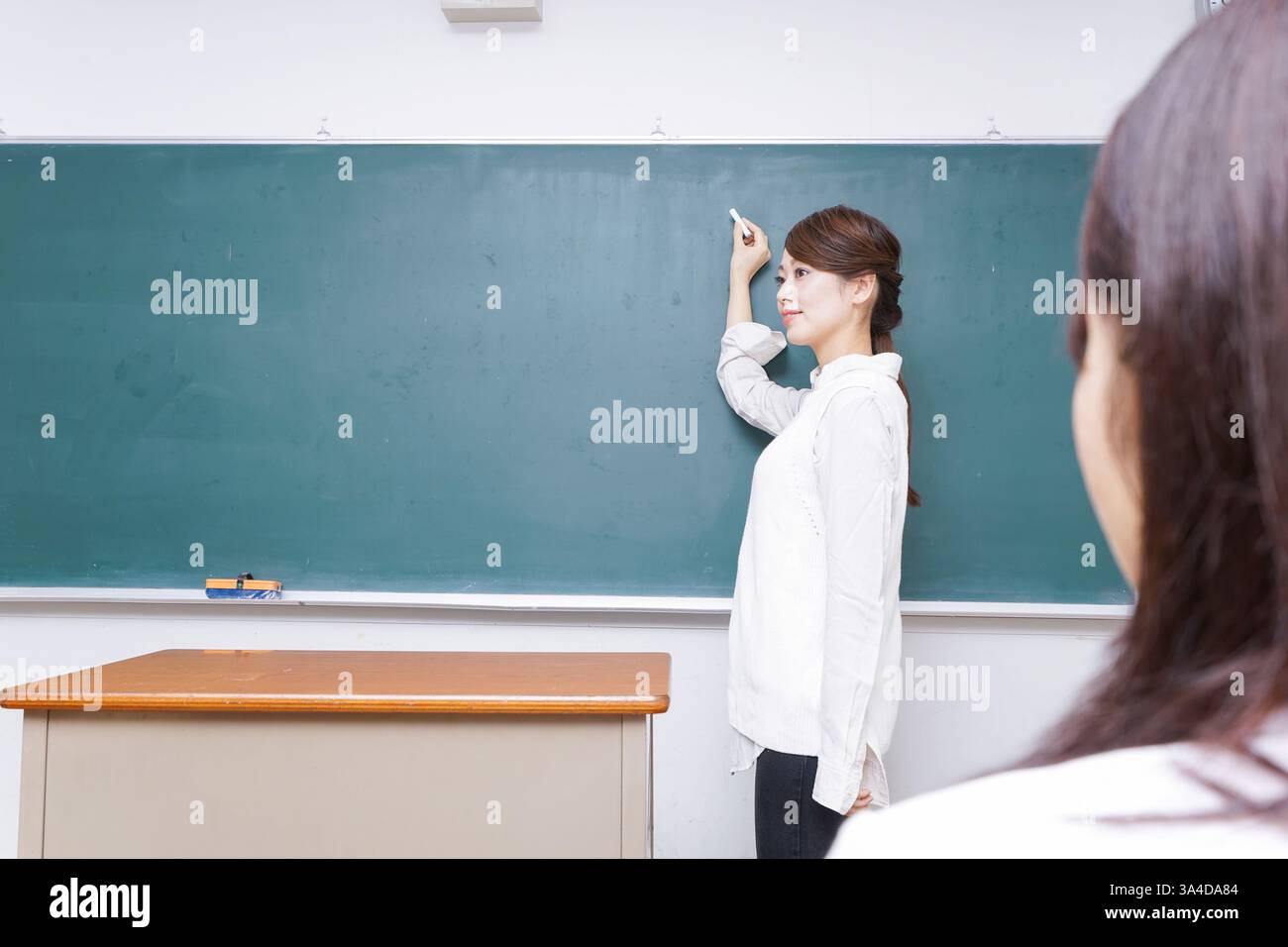 Teacher giving a lesson at school Stock Photo - Alamy