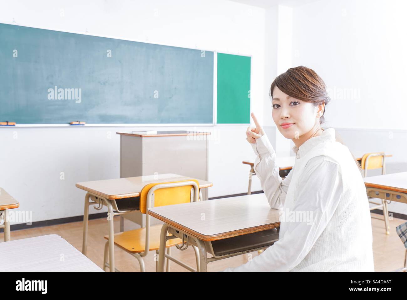 Student pointing fingers in classroom Stock Photo - Alamy