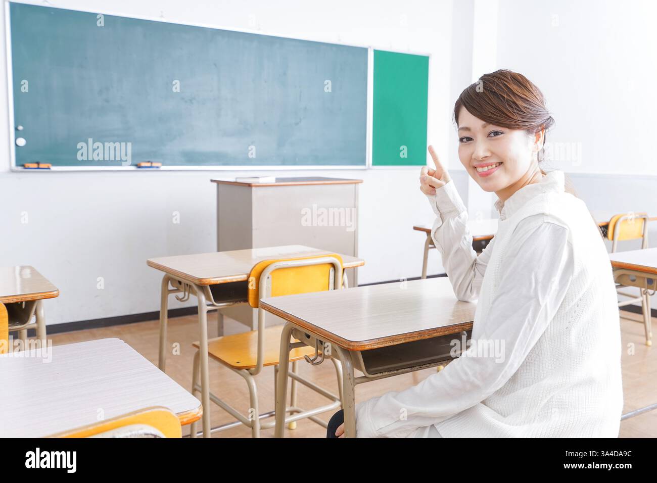 Student pointing fingers in classroom Stock Photo - Alamy