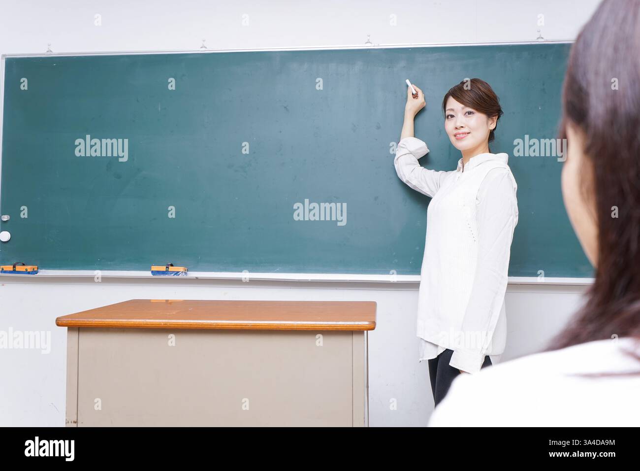 Teacher giving a lesson at school Stock Photo - Alamy