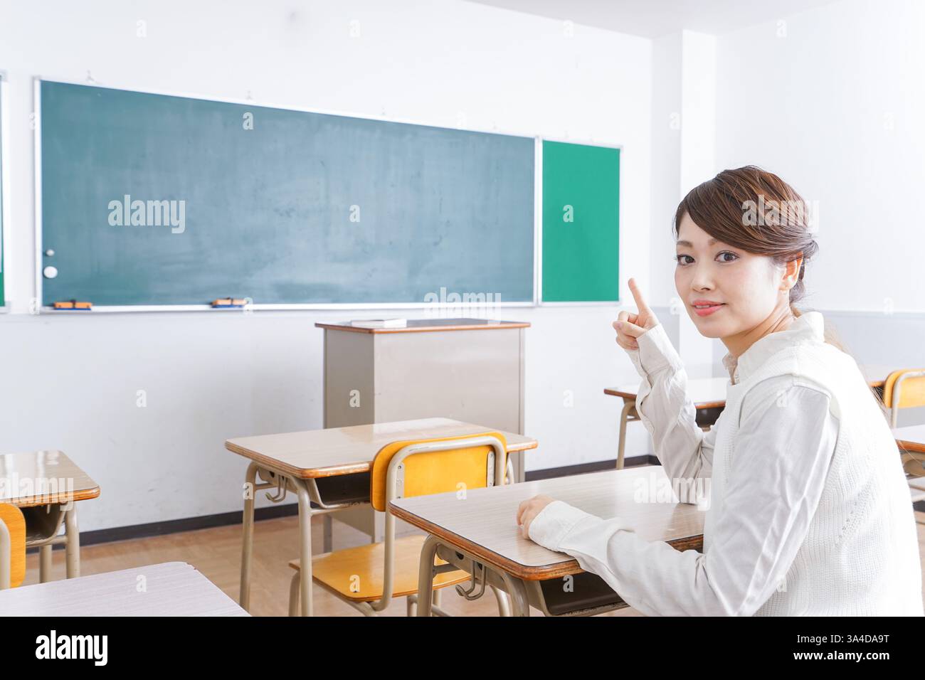Student pointing fingers in classroom Stock Photo - Alamy