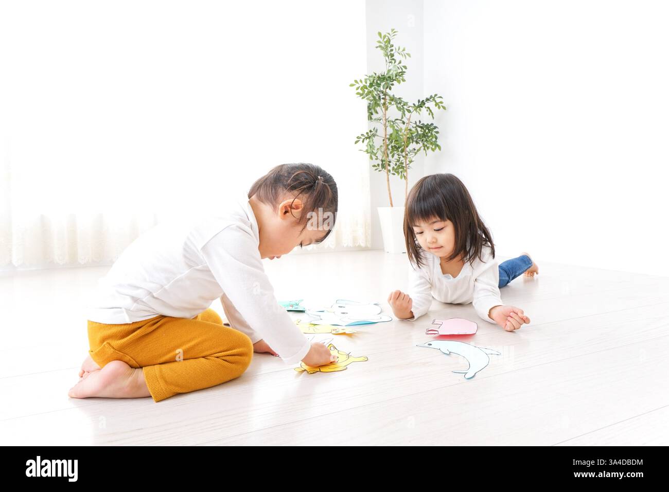 Two children playing indoors Stock Photo - Alamy