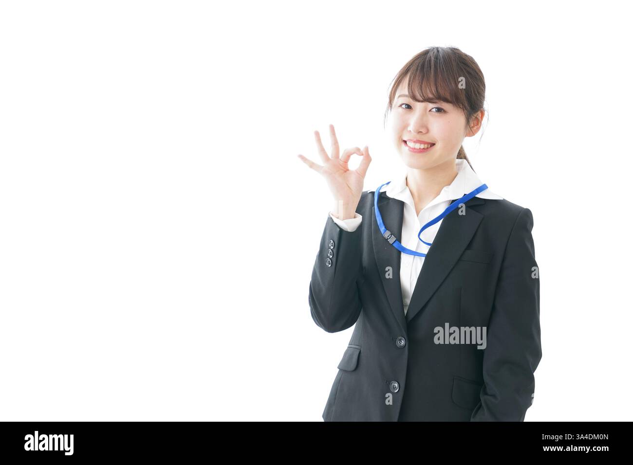 Smiling businesswoman showing the OK sign Stock Photo - Alamy