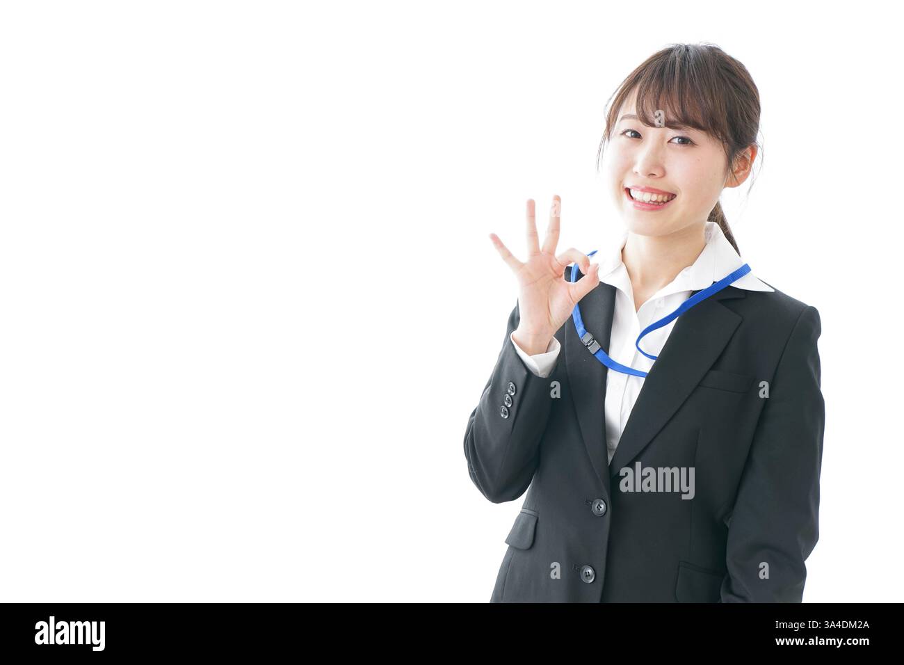 Smiling businesswoman showing the OK sign Stock Photo - Alamy