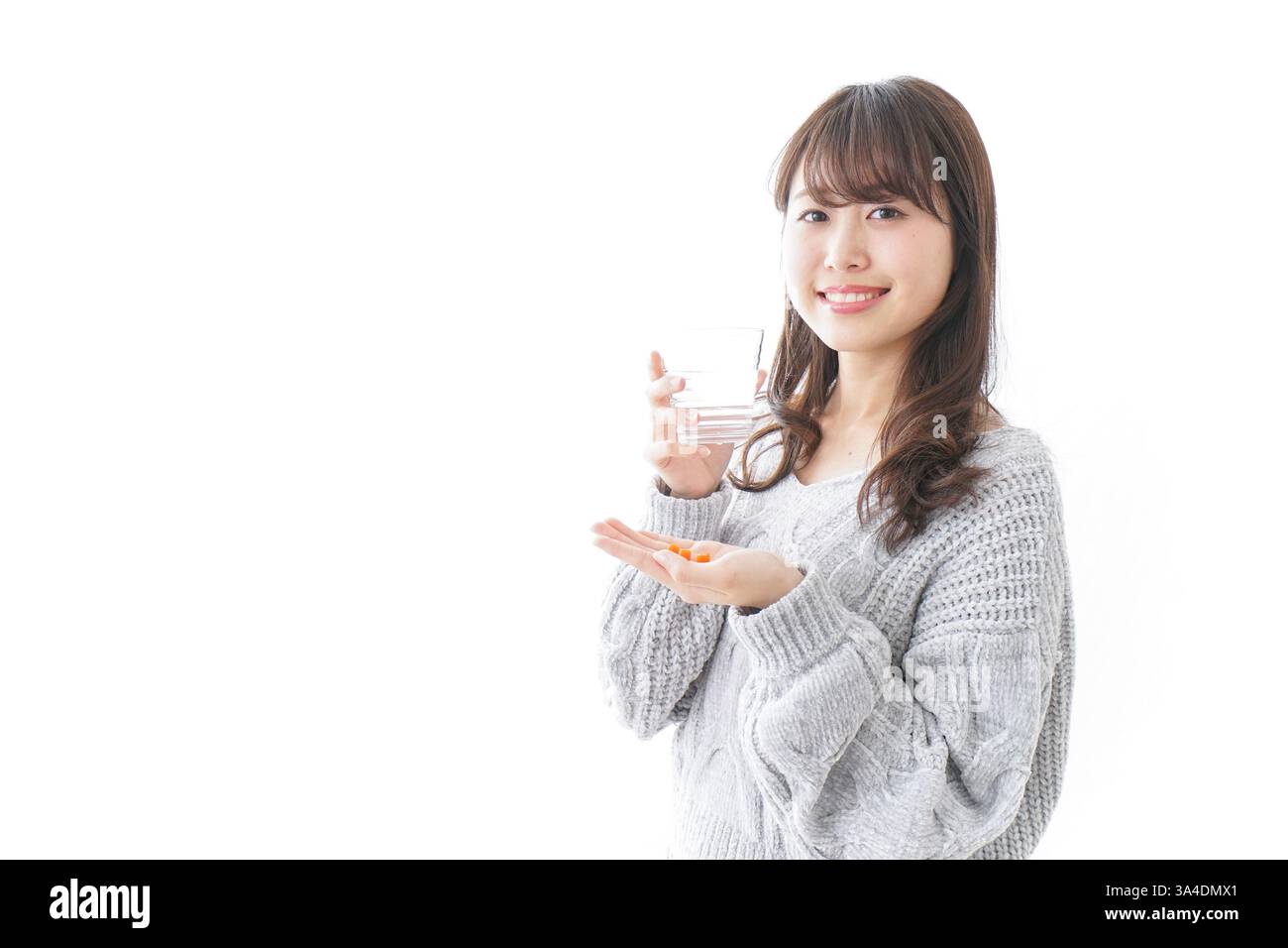 Woman taking tablets/supplements Stock Photo - Alamy