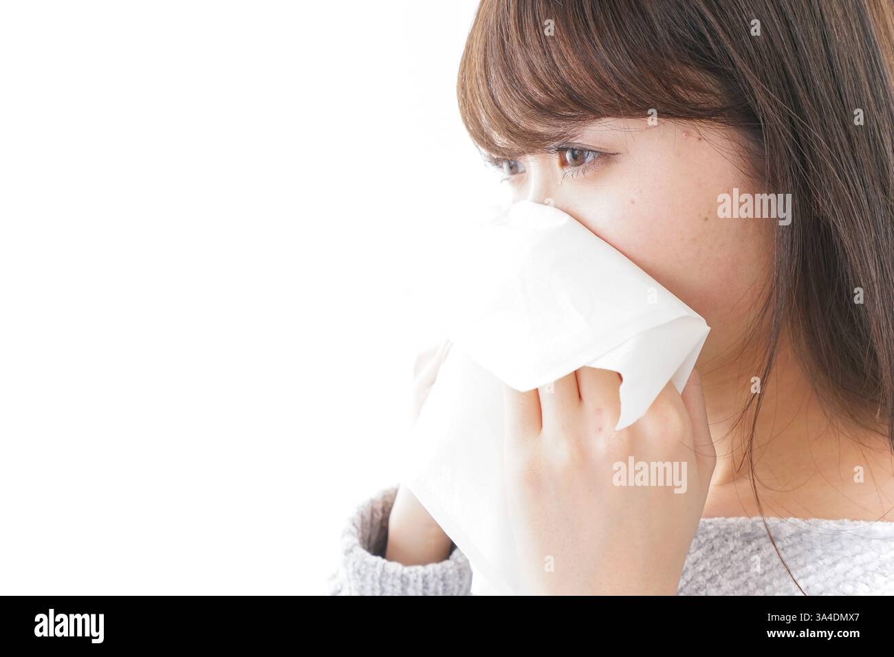 Woman blowing nose due to cold or hay fever Stock Photo - Alamy