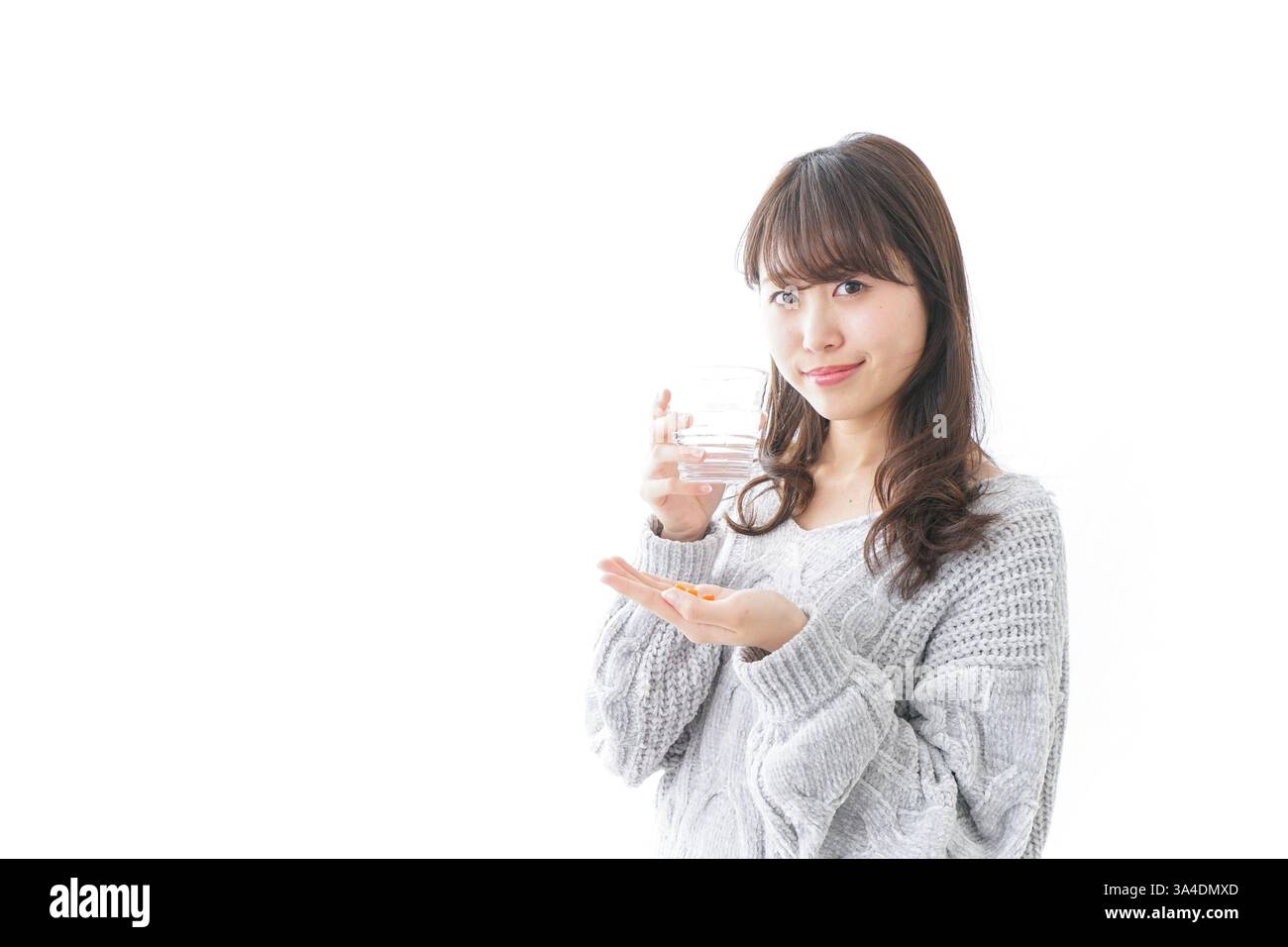 Woman taking tablets/supplements Stock Photo - Alamy