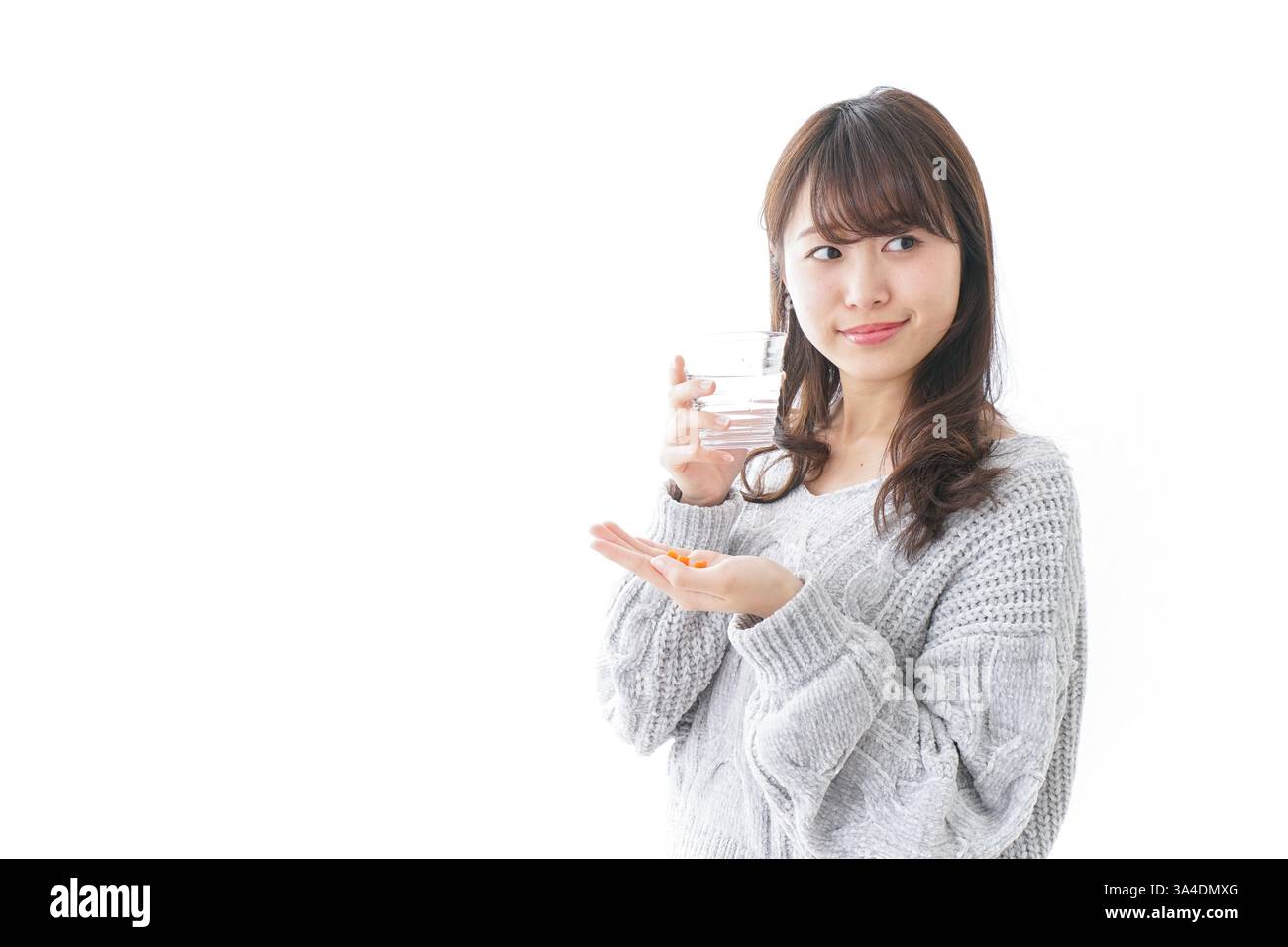 Woman taking tablets/supplements Stock Photo - Alamy