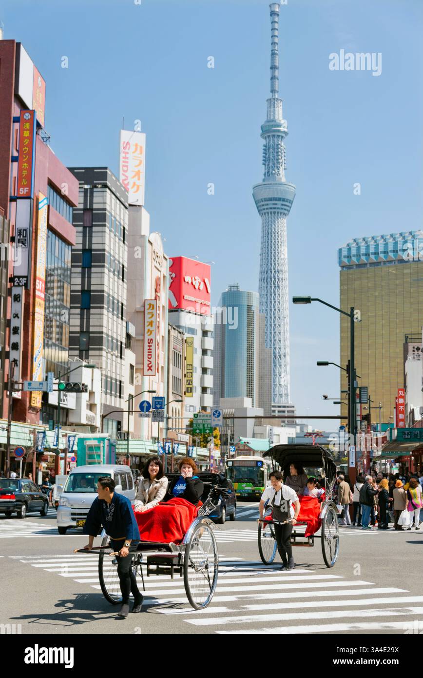 Tokyo Sky Tree in the distance, a Jin-Rikisha driver passes the ...