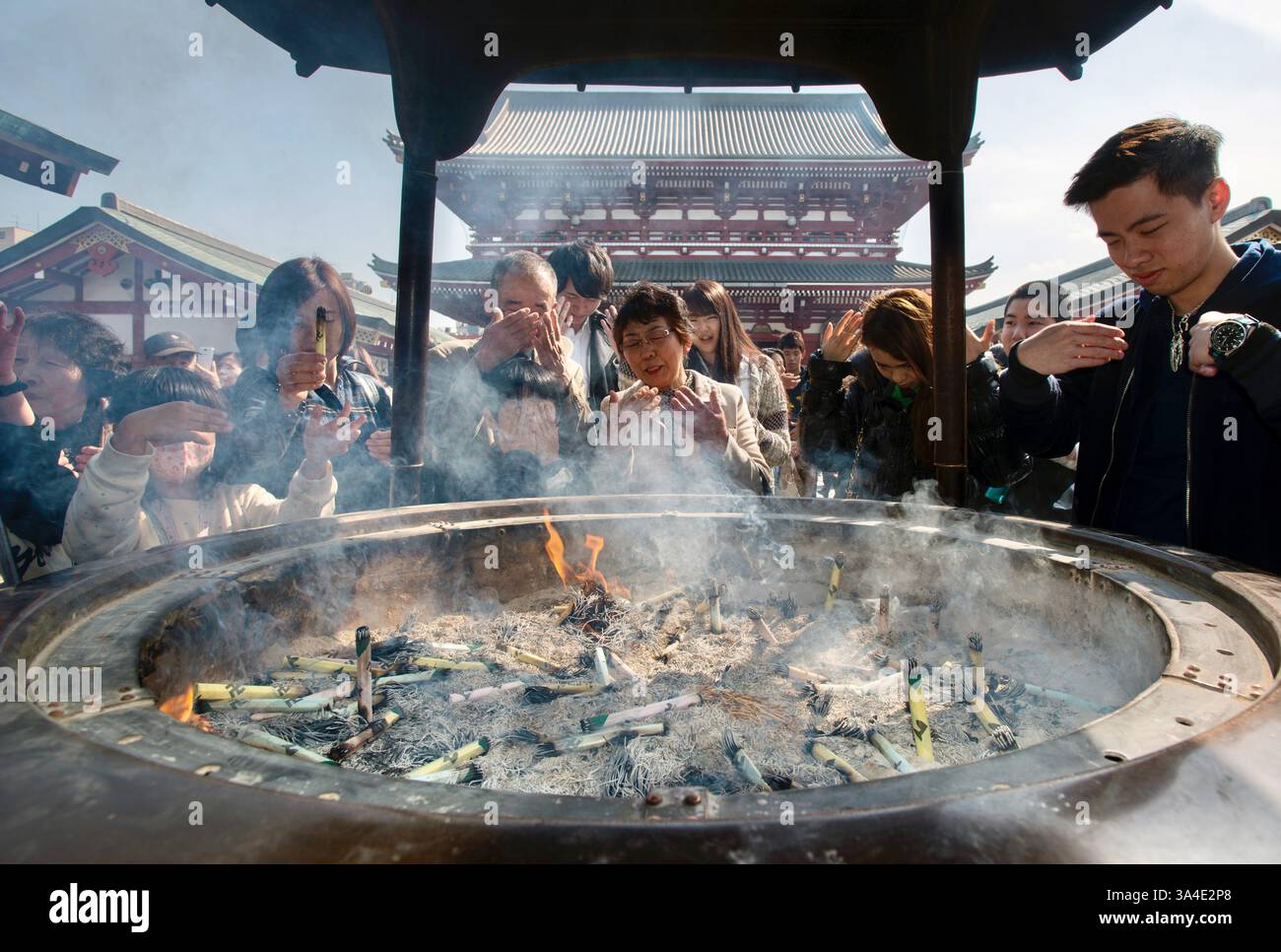 Worshippers perform a purification ritual in front of the main hall at ...