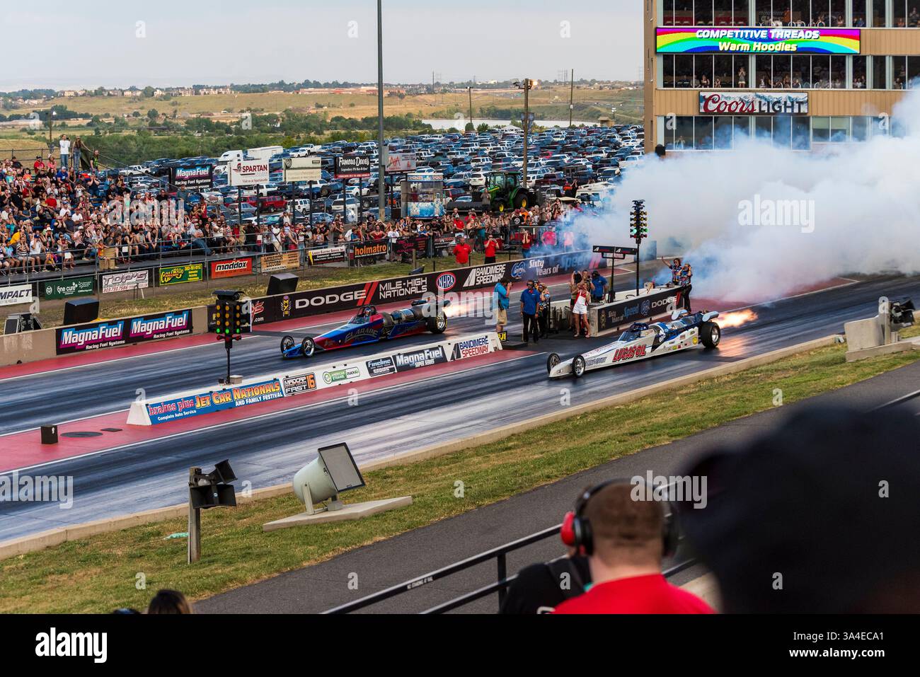 Drag Racing Event With Cars, Smoke, and a Large Audience at a Racing ...