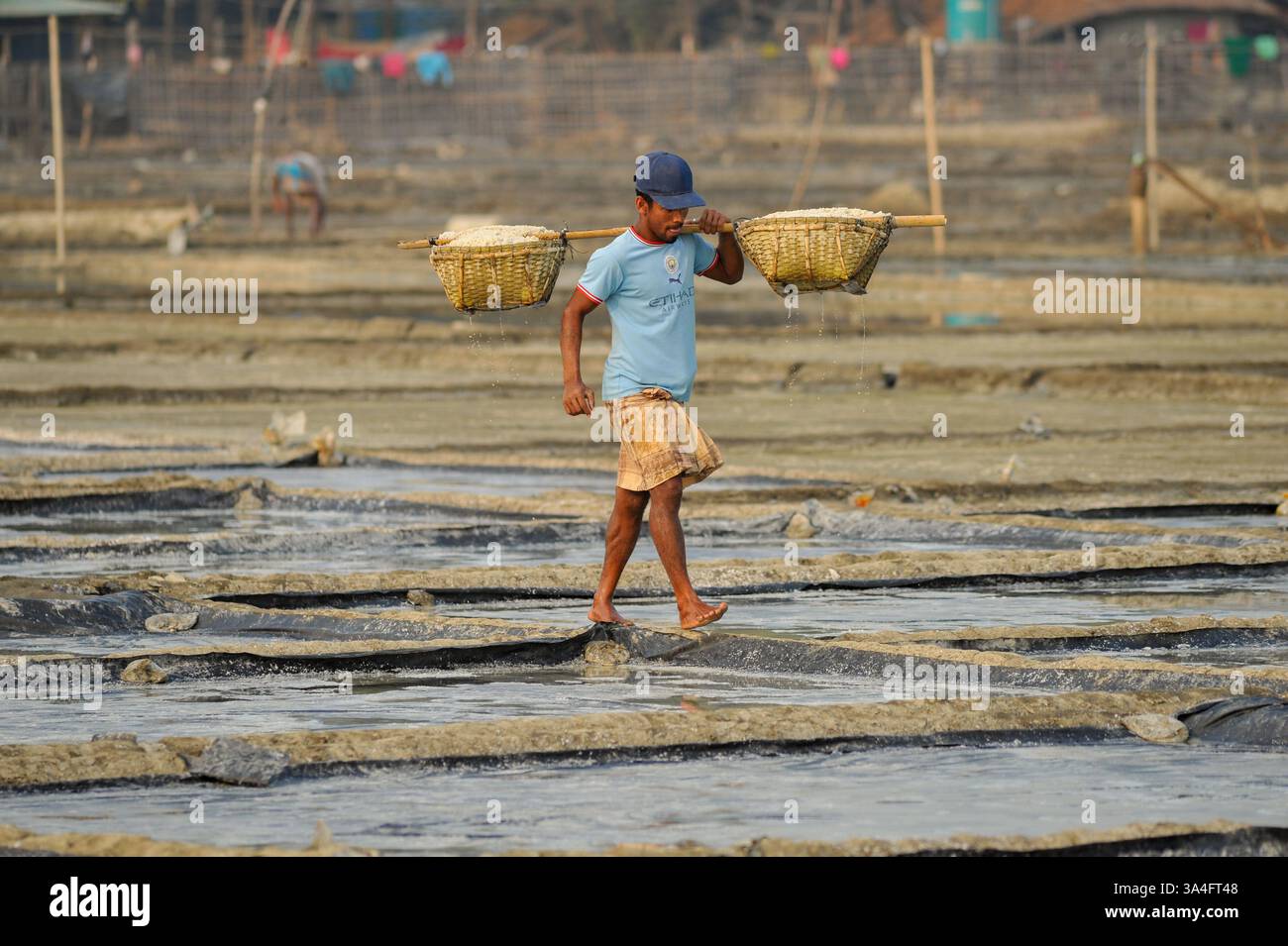Barefoot in the salt beds, laborers, including children, work ...