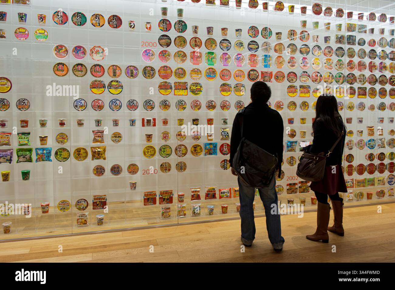 Visitors viewing the product display walls inside the Instant Noodles ...