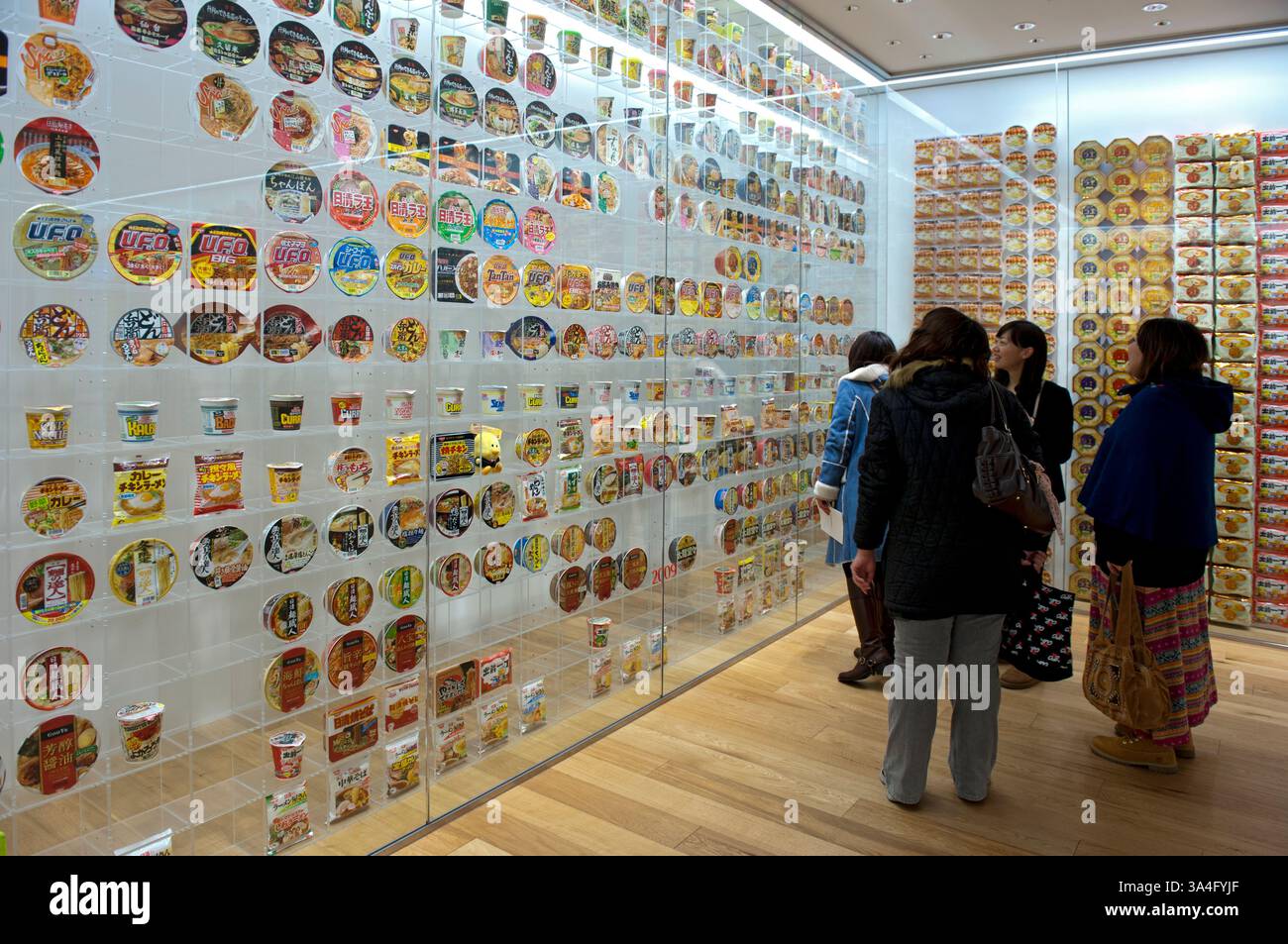 Visitors viewing the product display walls inside the Instant Noodles ...
