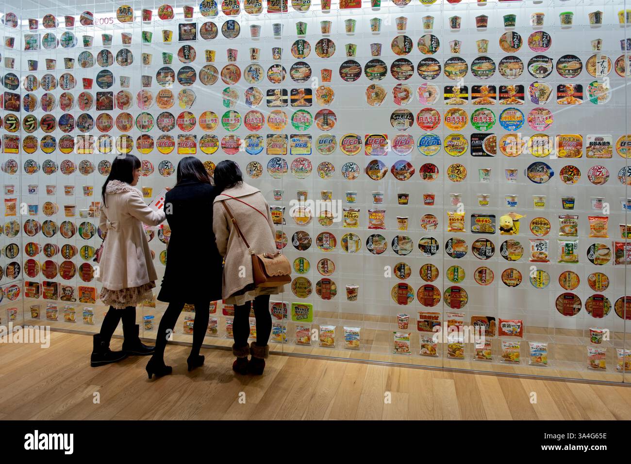 Visitors viewing the product display walls inside the Instant Noodles ...