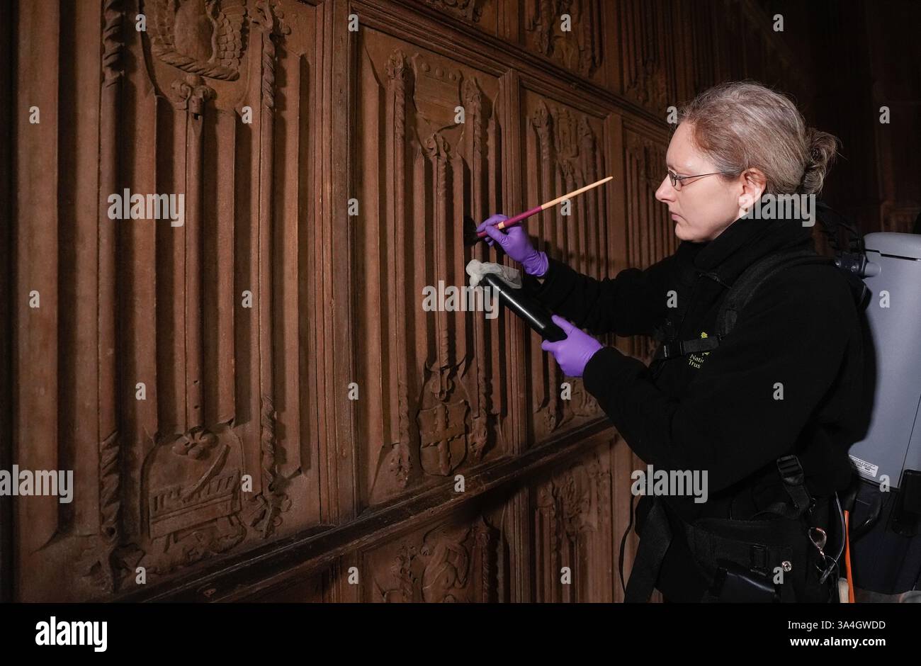 Staff clean panels following conservation work to safeguard the future ...