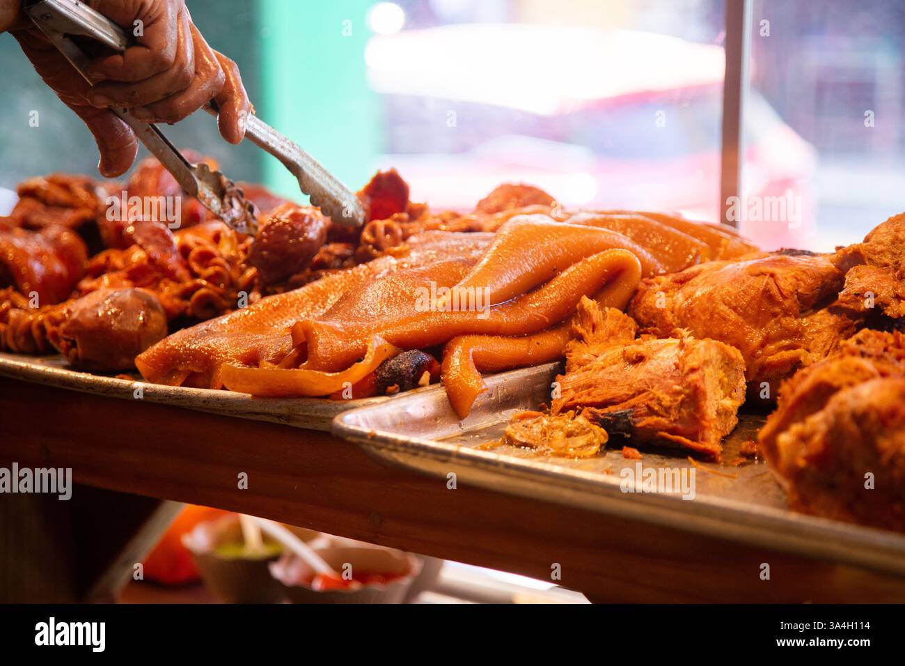 Food stall at a market selling the famous Mexican pork carnitas tacos ...
