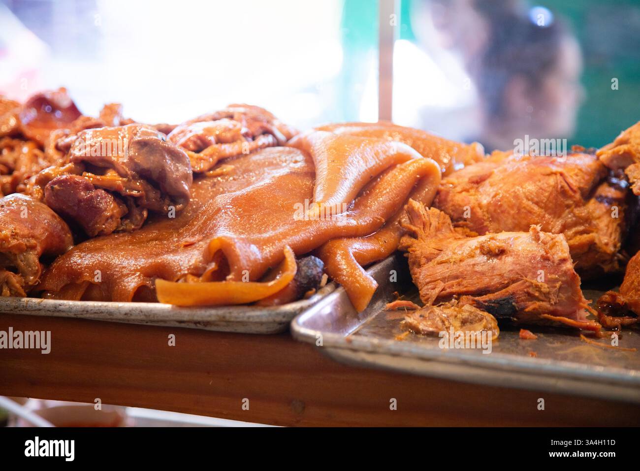 Food stall at a market selling the famous Mexican pork carnitas tacos ...