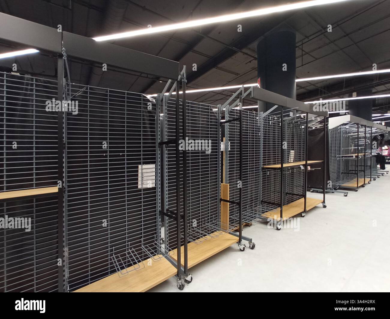 Empty retail store shelves with metal racks Stock Photo - Alamy
