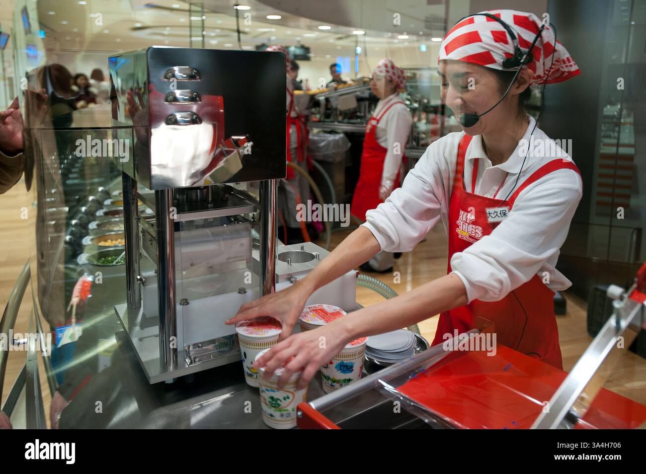 Workers making custom cup noodles to order at the My Cup Noodles ...