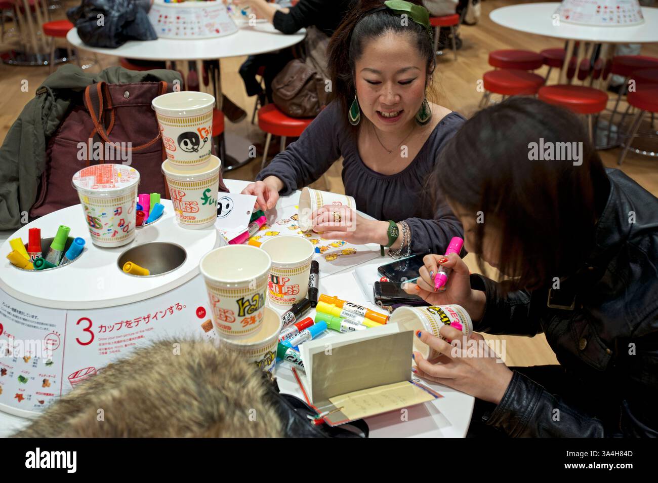 Visitors making custom containers of Nissin cup noodles at the Cup ...