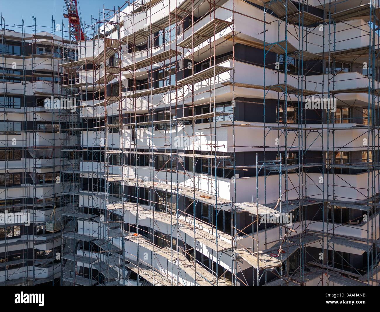 Construction progress of a modern residential building with scaffolding ...